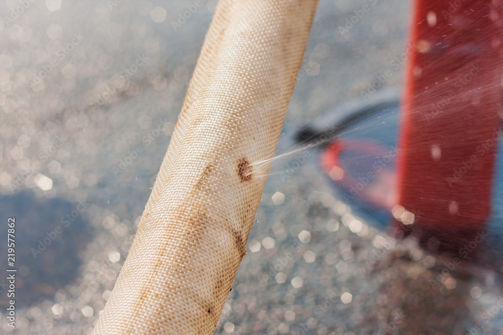 Damaged fire hose from a fire hydrant - water spray Stock Photo | Adobe ...