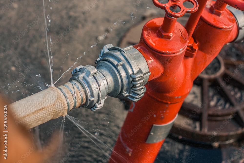 Damaged fire hose from a fire hydrant - water spray Stock Photo | Adobe ...