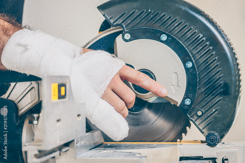 Bandaged hand with a cut off little finger near the miter saw Stock ...
