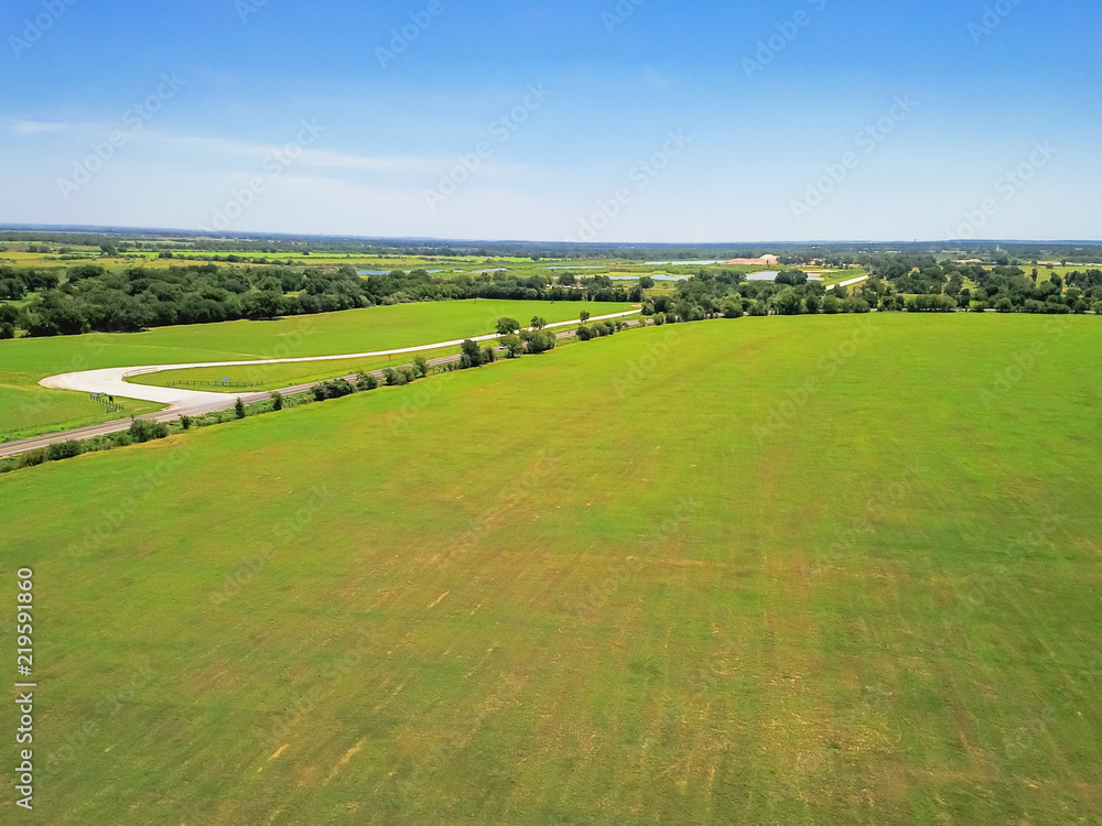Aerial view green farmland and rolling hill landscape with scenic drive ...