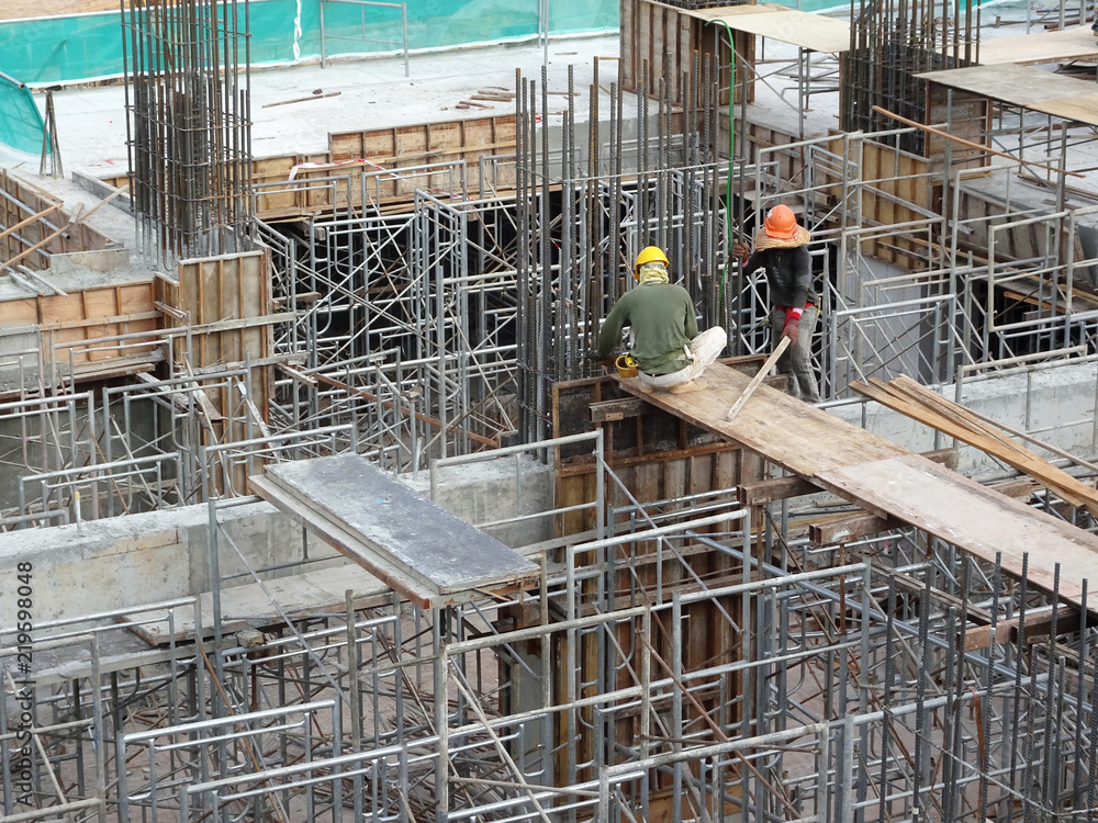 Construction workers installing reinforcement bar at the construction ...