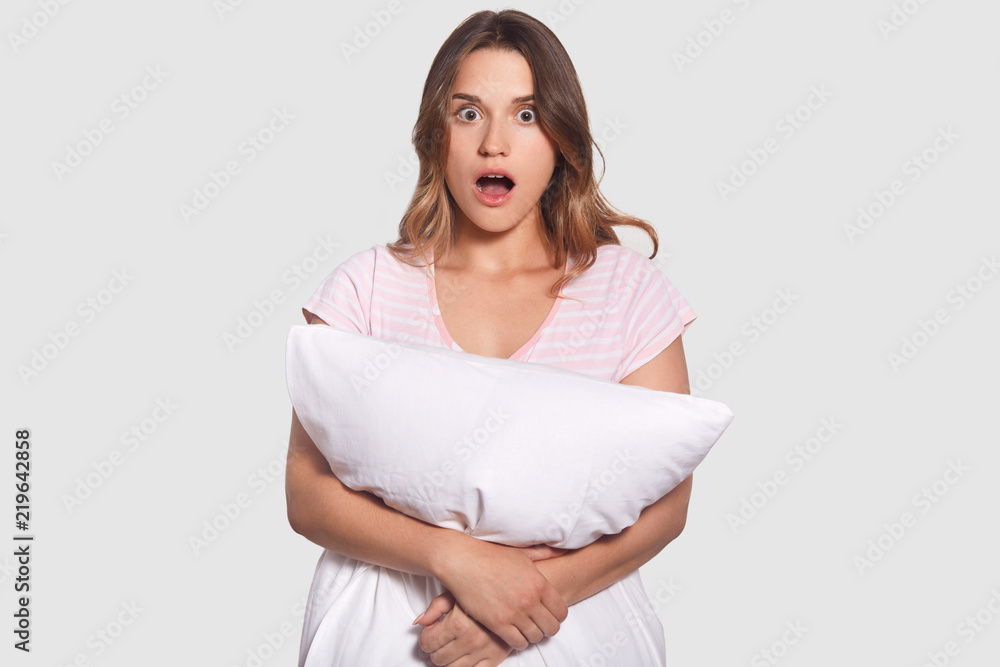 Astonished woman gets up at night, has shocked expression after seeing ...
