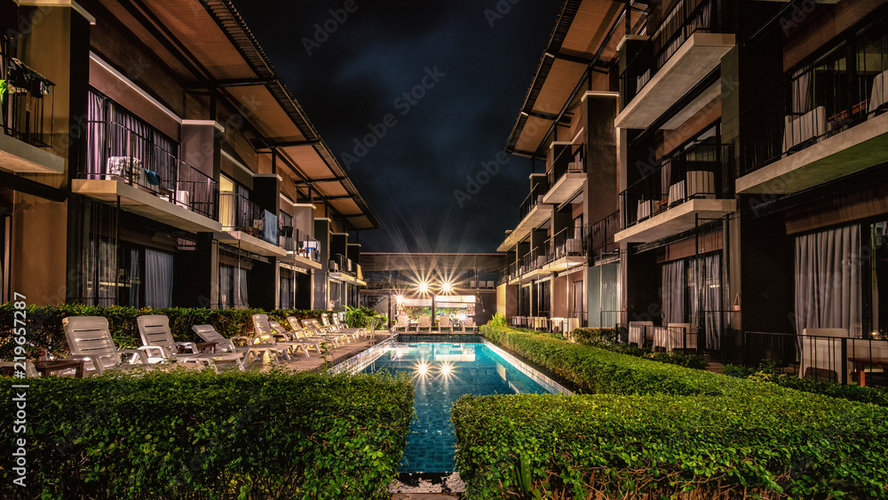 long exposure night shot image of poolside resort building with ...