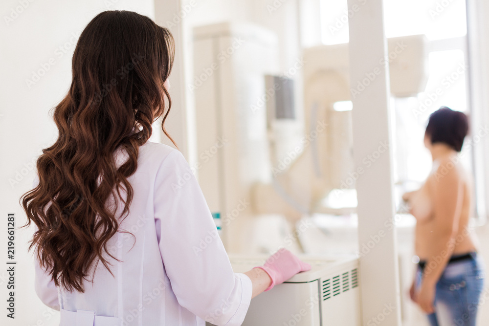 Back view of the young excellent breast specialist who is carrying up ...