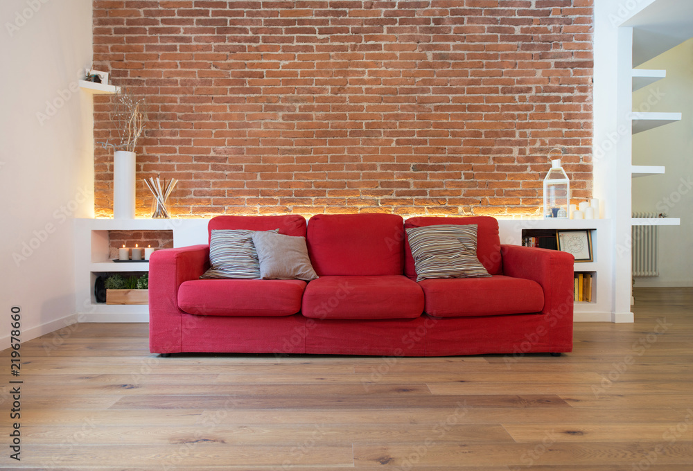 Modern living room with red sofa and brick wall Stock Photo | Adobe Stock