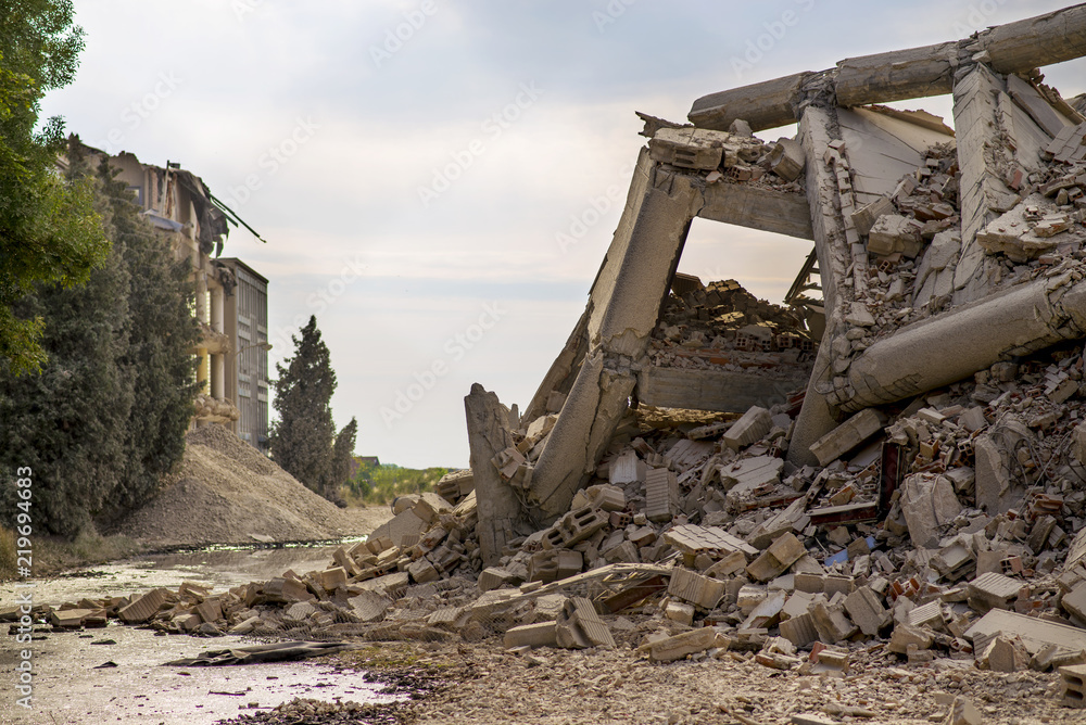 Industrial concrete building destructed by strike. Disaster scene full ...