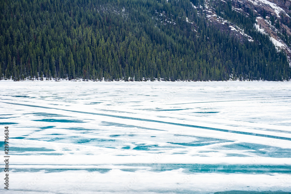 Lake Louise Frozen in Spring. Lake Louise is a hamlet in Banff National ...