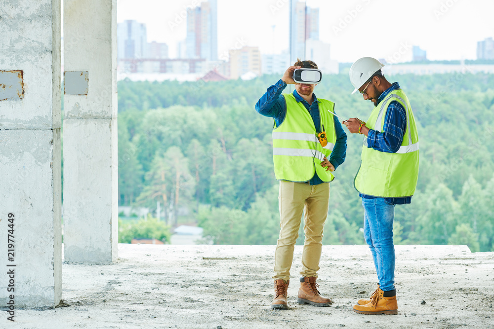 Full length portrait of two contemporary workers using VR to visualize ...