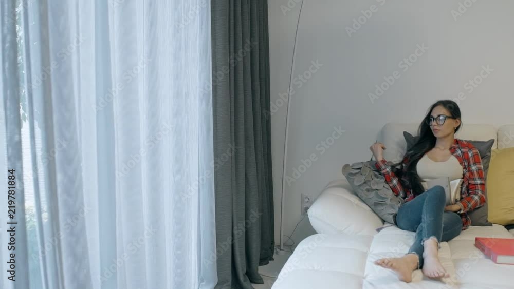 Smart female student finishing her homework at home. Young woman in ...