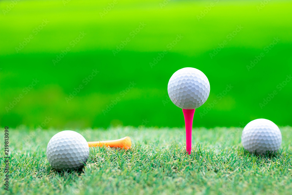 Golf ball on tee on golf course. Stock Photo | Adobe Stock