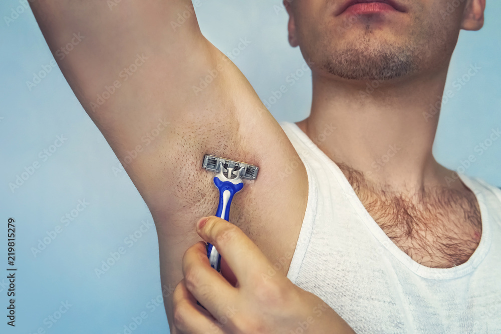 underarm hair removal. Male depilation. Young attractive muscular man ...