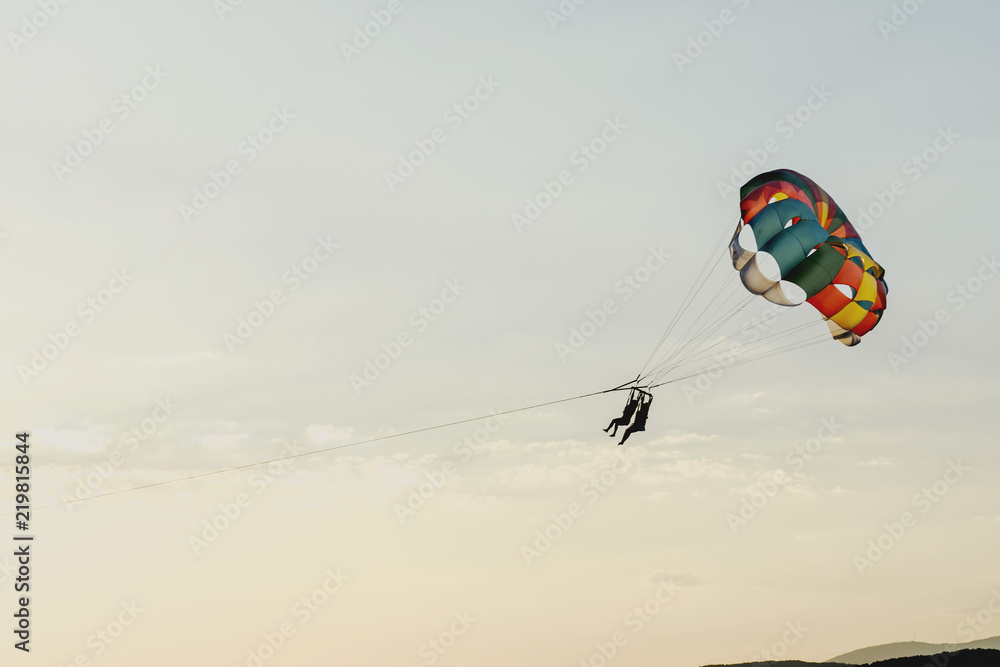 Round parachute against the sunset sky with clouds in an unusual color ...
