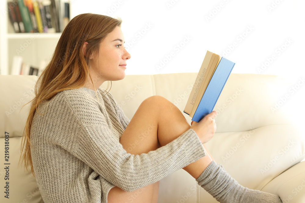 Profile of a teen reading a book at home Stock Photo | Adobe Stock