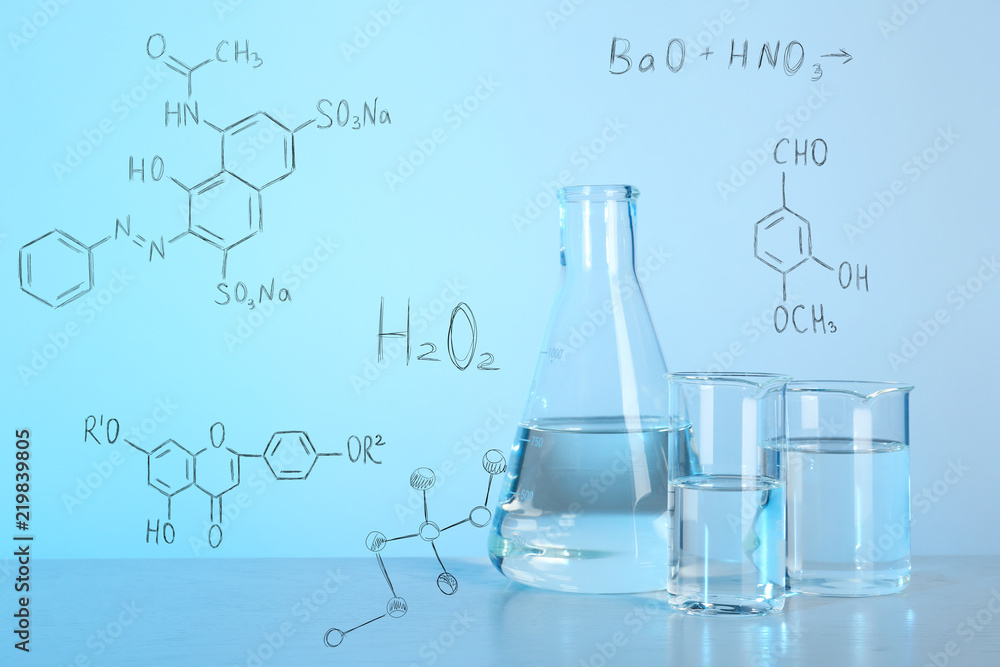 Laboratory glassware with liquids for analysis on table and chemical ...