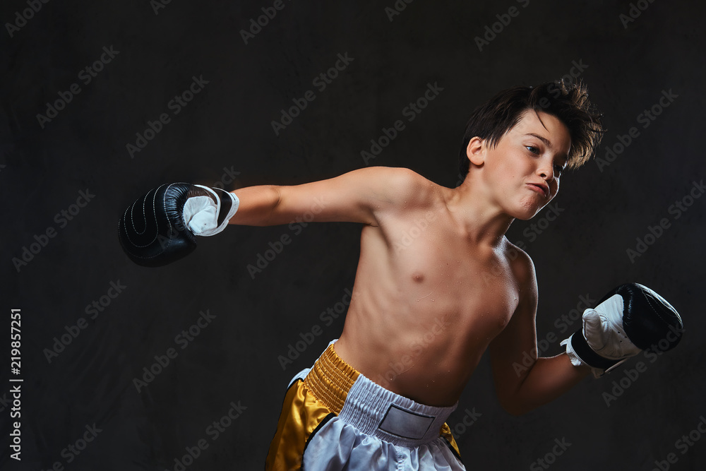 Handsome shirtless young boxer during boxing exercises, focused on ...
