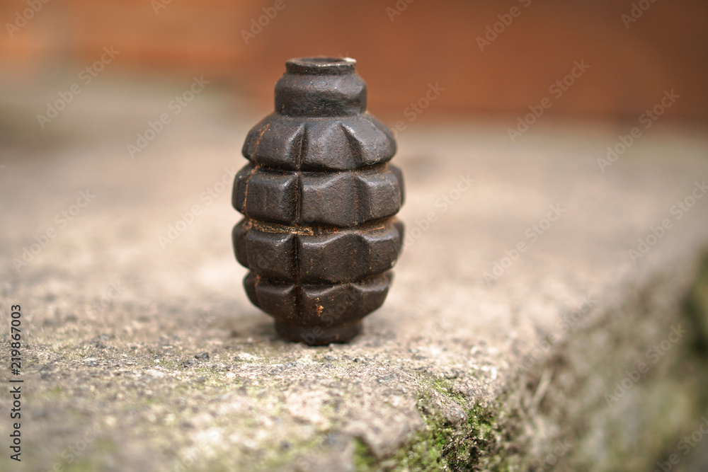 Neutralized grenade of the Second World War on a concrete background of ...