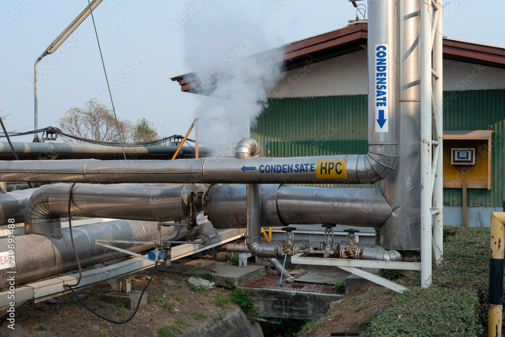 Leakage of steam in heat pipeline interior industrial gas with a lot of ...