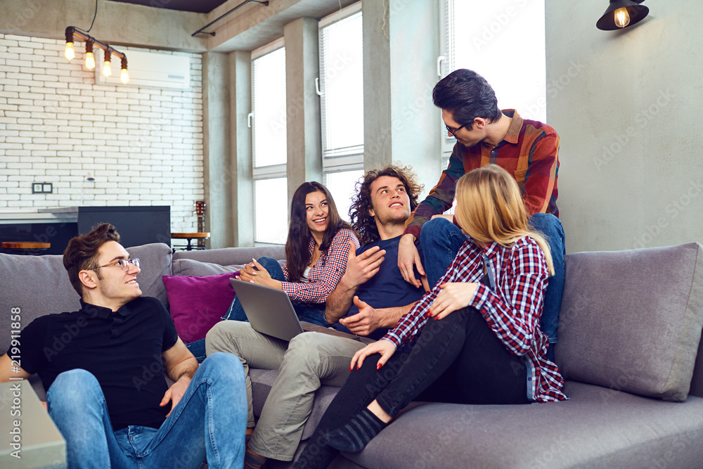 A group of young people have fun chatting at a meeting of friends ...