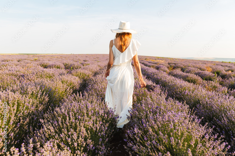 Back view of a pretty young girl in straw hat Stock Photo | Adobe Stock