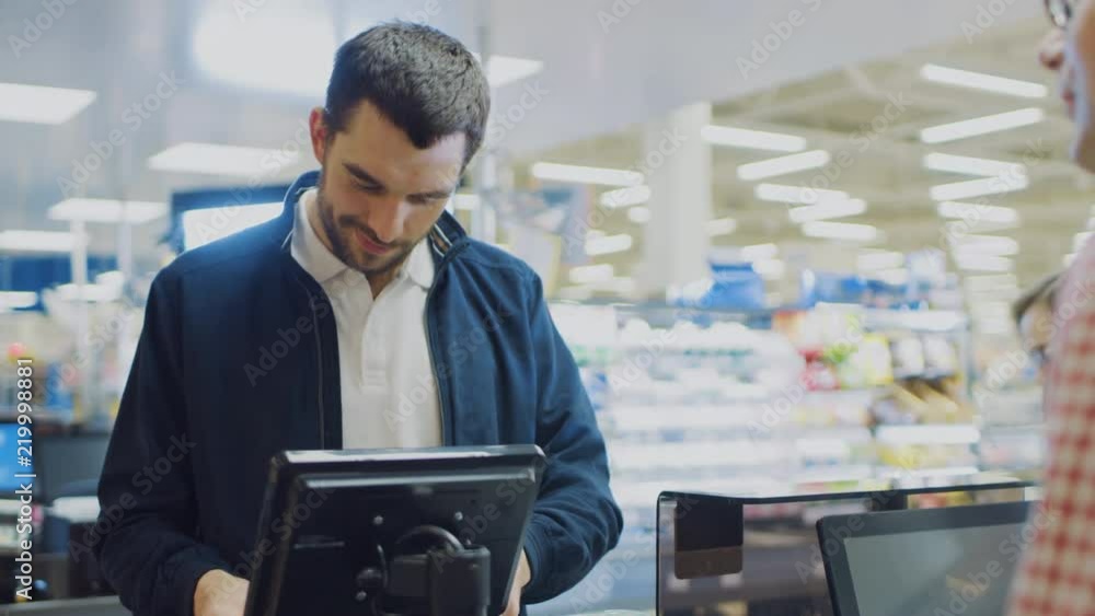 At the Supermarket: Checkout Counter Customer Pays with Smartphone for ...