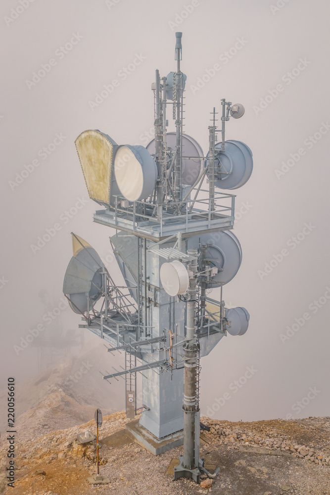 Communication tower with many antenna the mountains, looks like ...