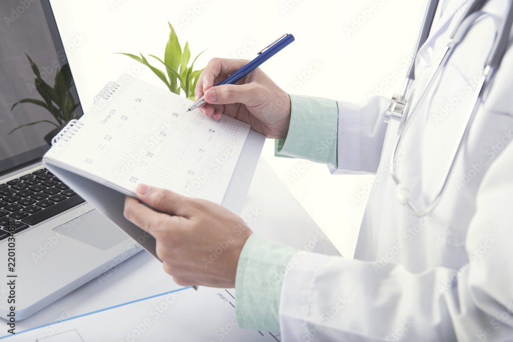 doctor hand marked appointment for patient on calendar. concept planner ...