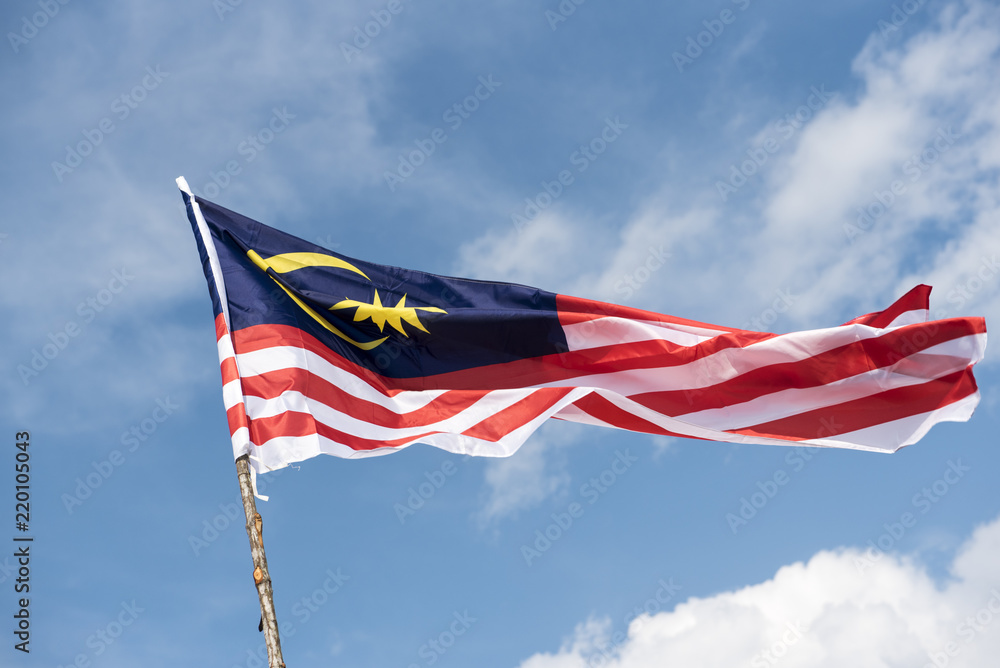 Malaysia flag also known as Jalur Gemilang wave with the blue sky ...