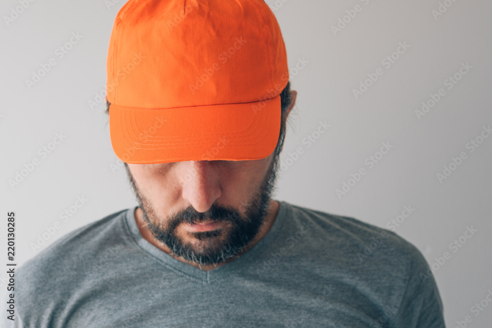 Man wearing orange baseball cap for mockup Stock Photo | Adobe Stock
