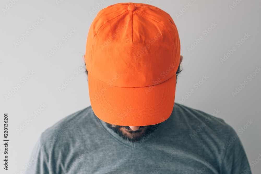 Man wearing orange baseball cap for mockup Stock Photo | Adobe Stock