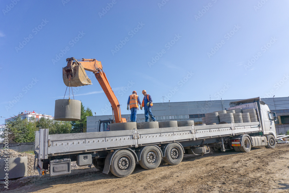 Delivery and unloading of construction materials by the excavator to ...