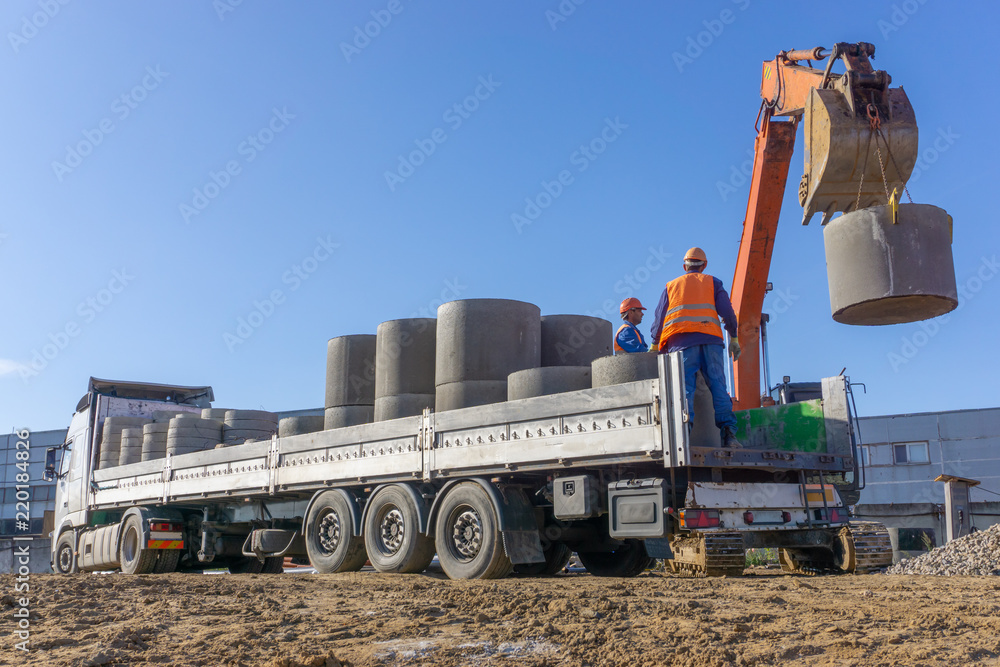 Delivery and unloading of construction materials by the excavator to ...