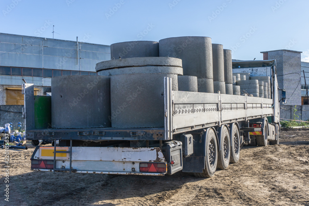Delivery of building materials for construction site. Concrete rings ...
