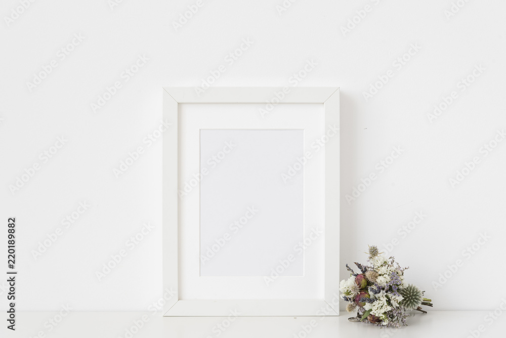 Minimal white a5 portrait frame mockup with small bouquet of dried ...