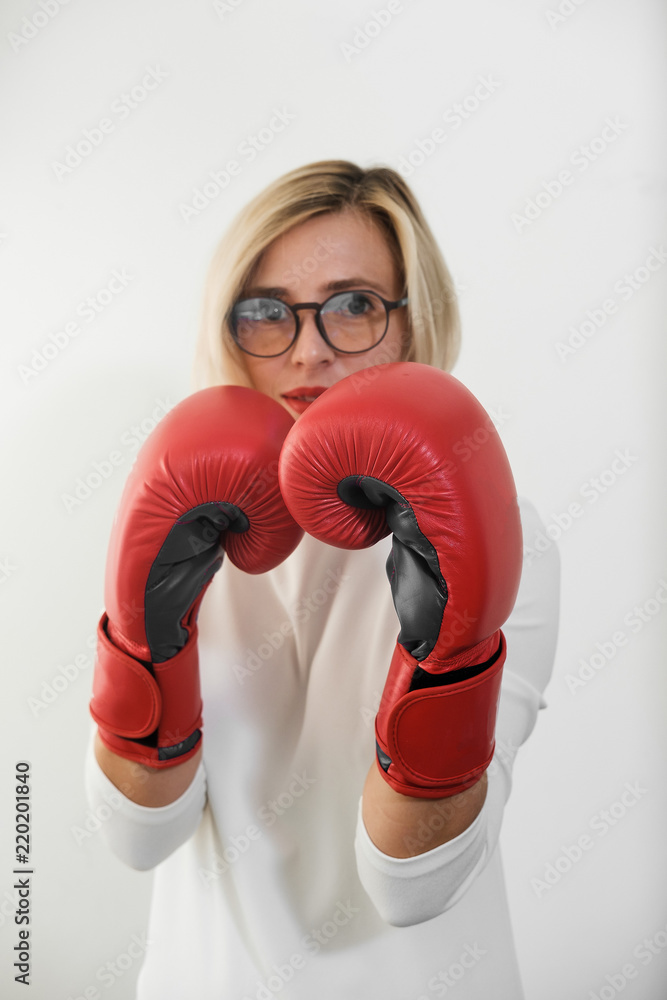 young woman with red boxing gloves. Girl in red dress are fighting ...