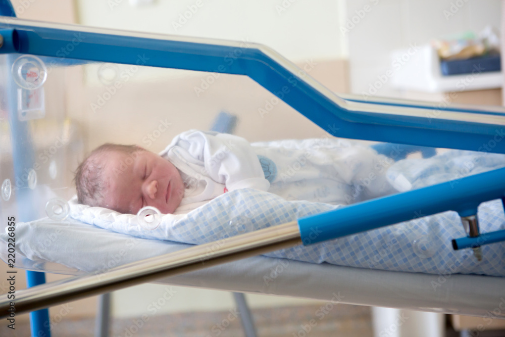 Newborn baby laying in crib in prenatal hospital Stock Photo | Adobe Stock