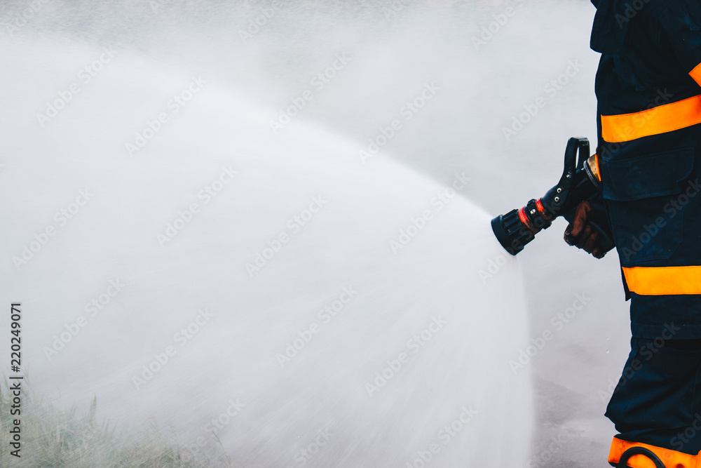 Firefighter using fire extinguisher and fire extinguisher, Firefighter ...