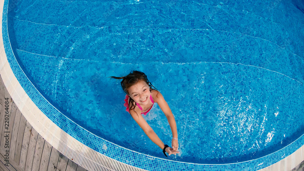 Little girl splashing in pool shallow water, top view Stock Photo ...