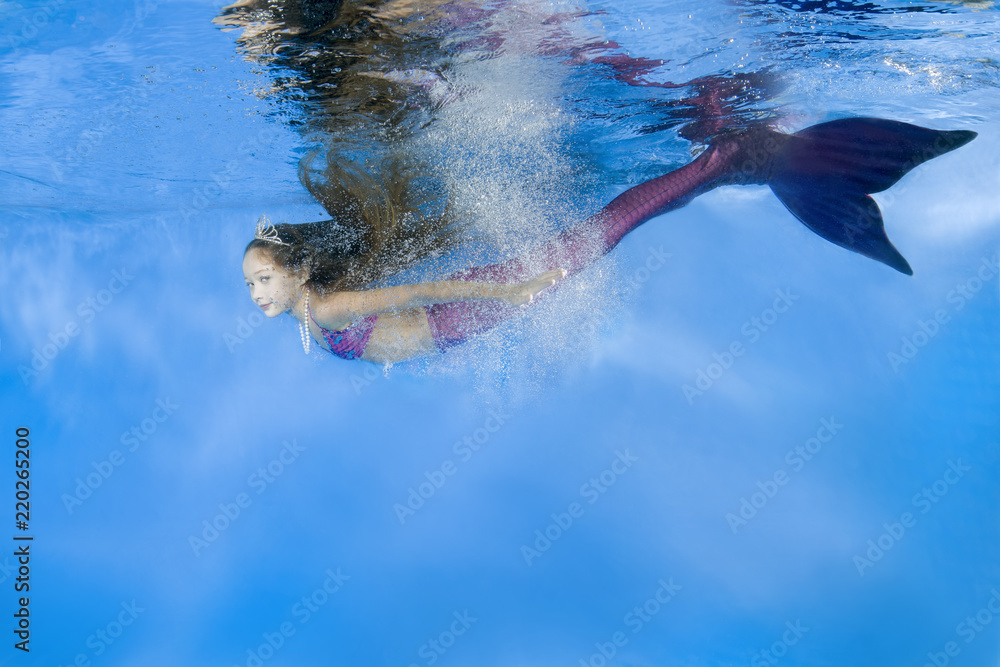 girl in mermaid costume wearing poses underwater Stock Photo | Adobe Stock