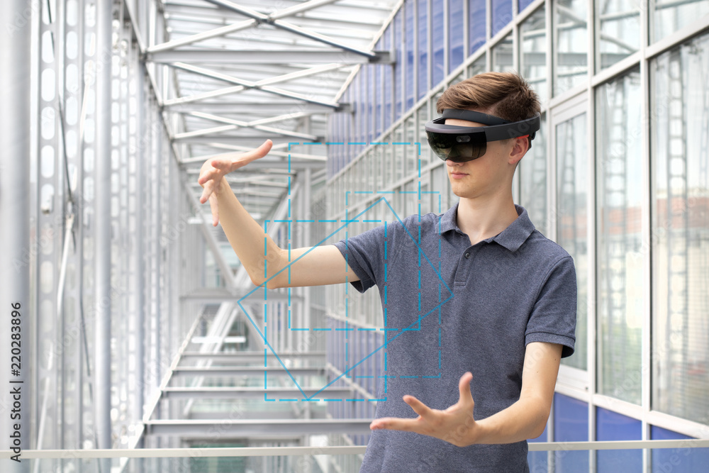 Portrait of young Caucasian teenager using augmented reality HoloLens ...