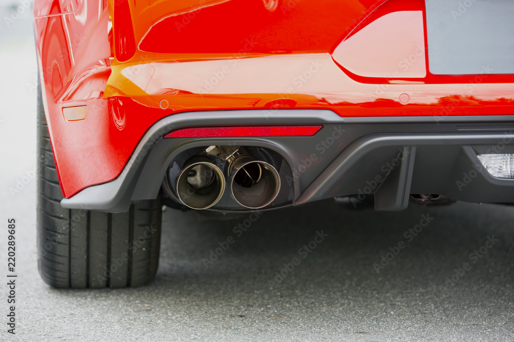 Dual exhaust on a modern sports car. Red muscle car with loud exhaust ...