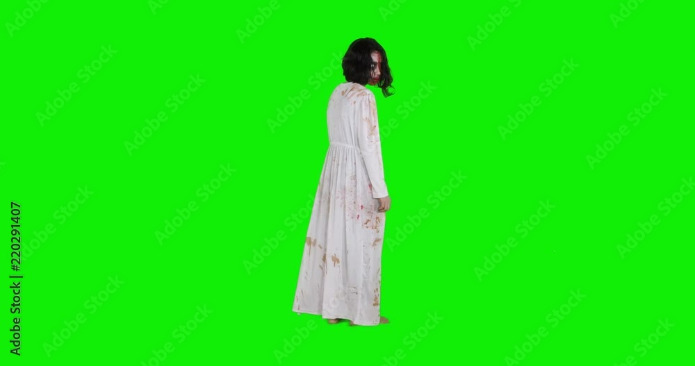 Creepy zombie woman with wounded face and white gown standing in the ...