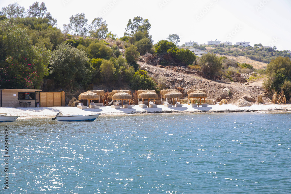 Sand tropic palms and sunbeds. Luxury vacation at crystal clear waters ...