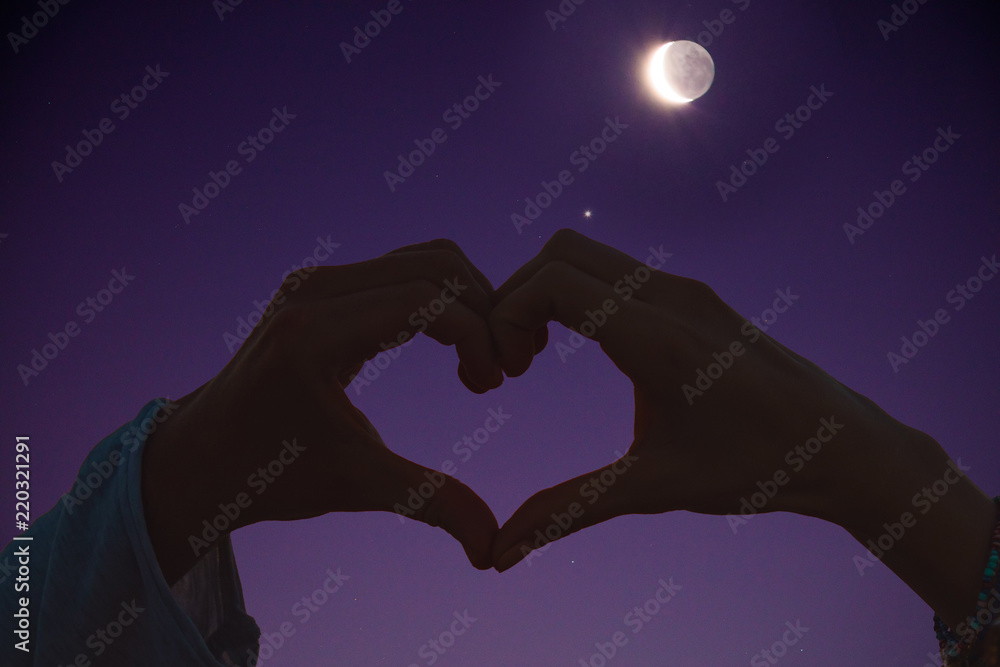 Silhouette of man and woman hands making a heart - shape symbol with ...