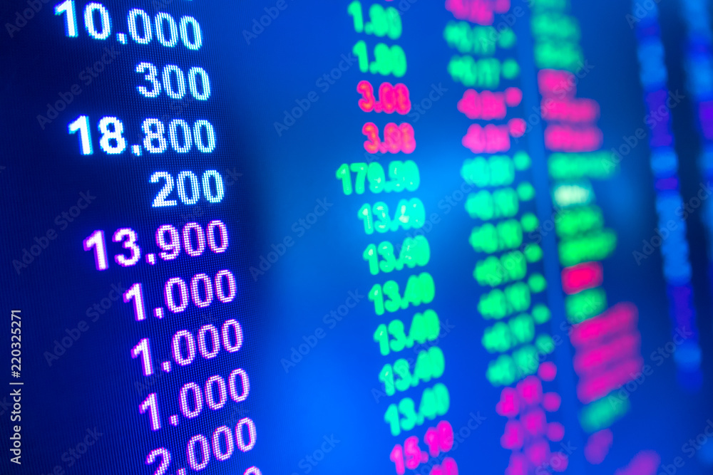 Stock market graph analysis. Stock market data on LED display on laptop ...