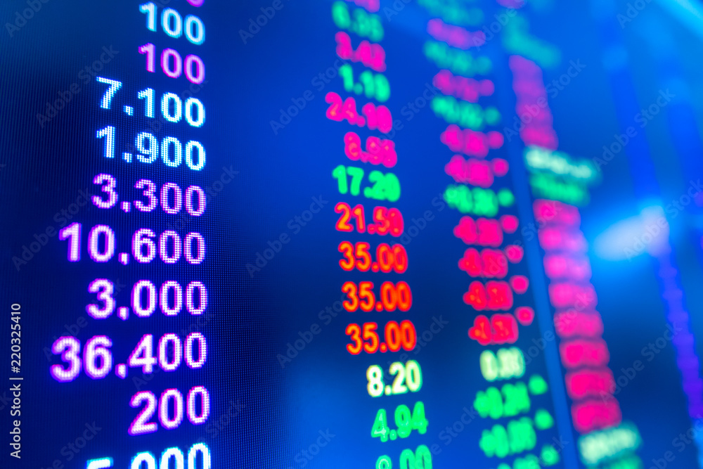 Stock market graph analysis. Stock market data on LED display on laptop ...