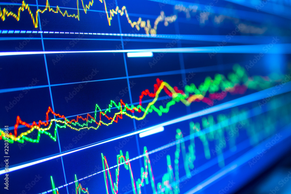 Stock market graph analysis. Stock market data on LED display on laptop ...