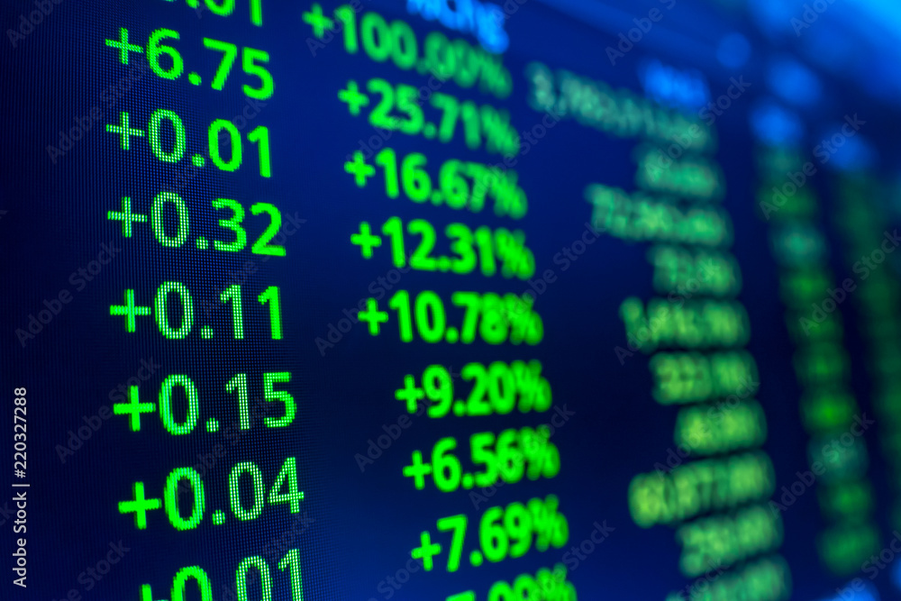 Stock market graph analysis. Stock market data on LED display on laptop ...