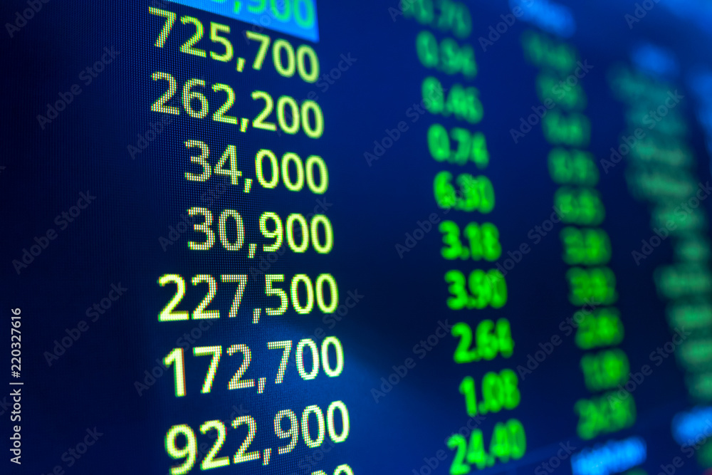 Stock market graph analysis. Stock market data on LED display on laptop ...