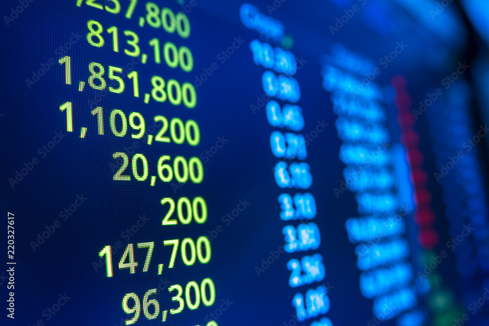 Stock market graph analysis. Stock market data on LED display on laptop ...