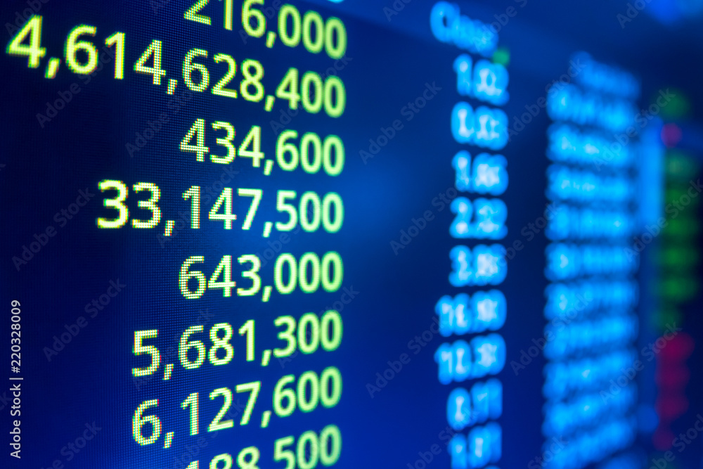 Stock market graph analysis. Stock market data on LED display on laptop ...